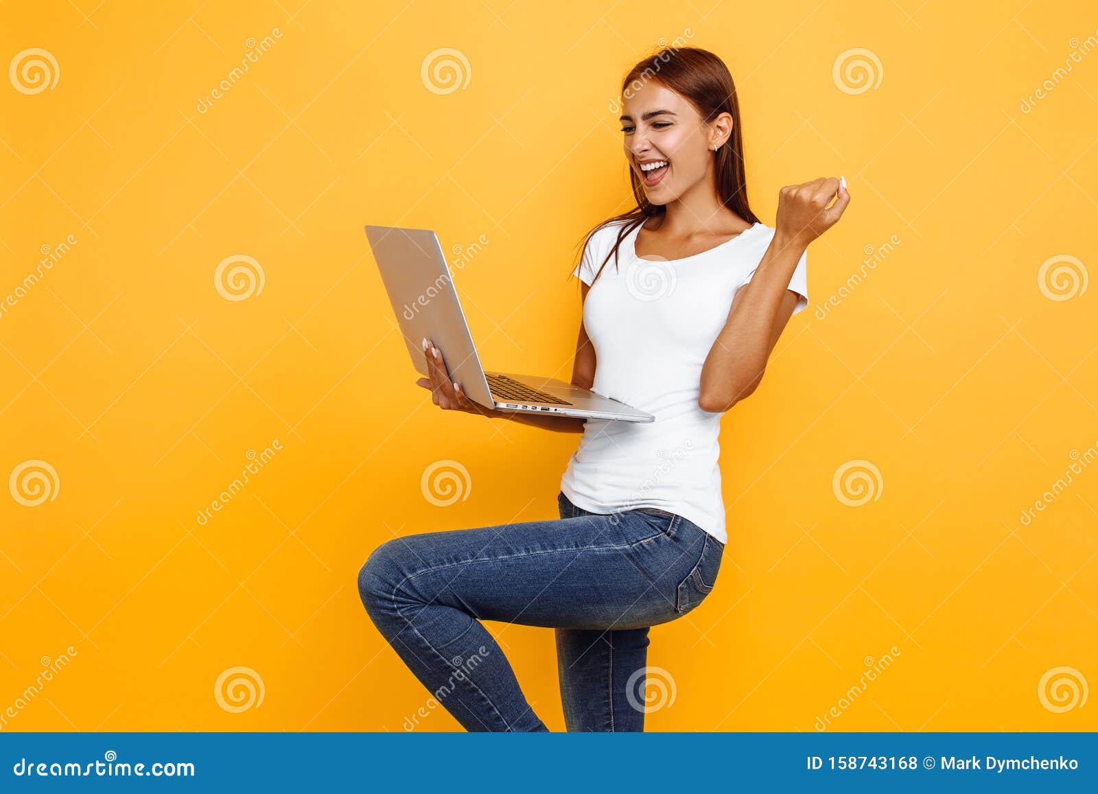 Portrait Of Excited Young Girl Holding Laptop And Celebrating Success ... Portrait Of Excited Young Girl Holding Laptop And Celebrating Success ...