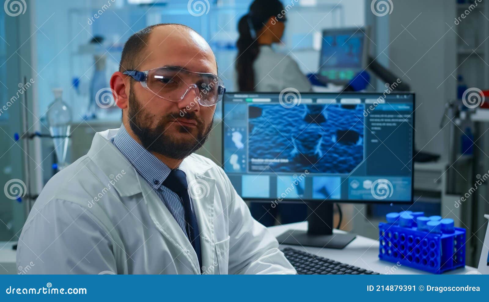 Portrait of Exhausted Scientist Man Looking at Camera Sitting in Front ...