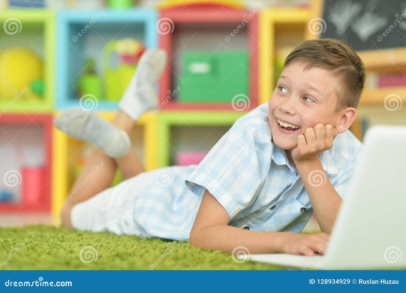 Portrait of Exited Boy Using Laptop while Lying on Floor Stock Image ...