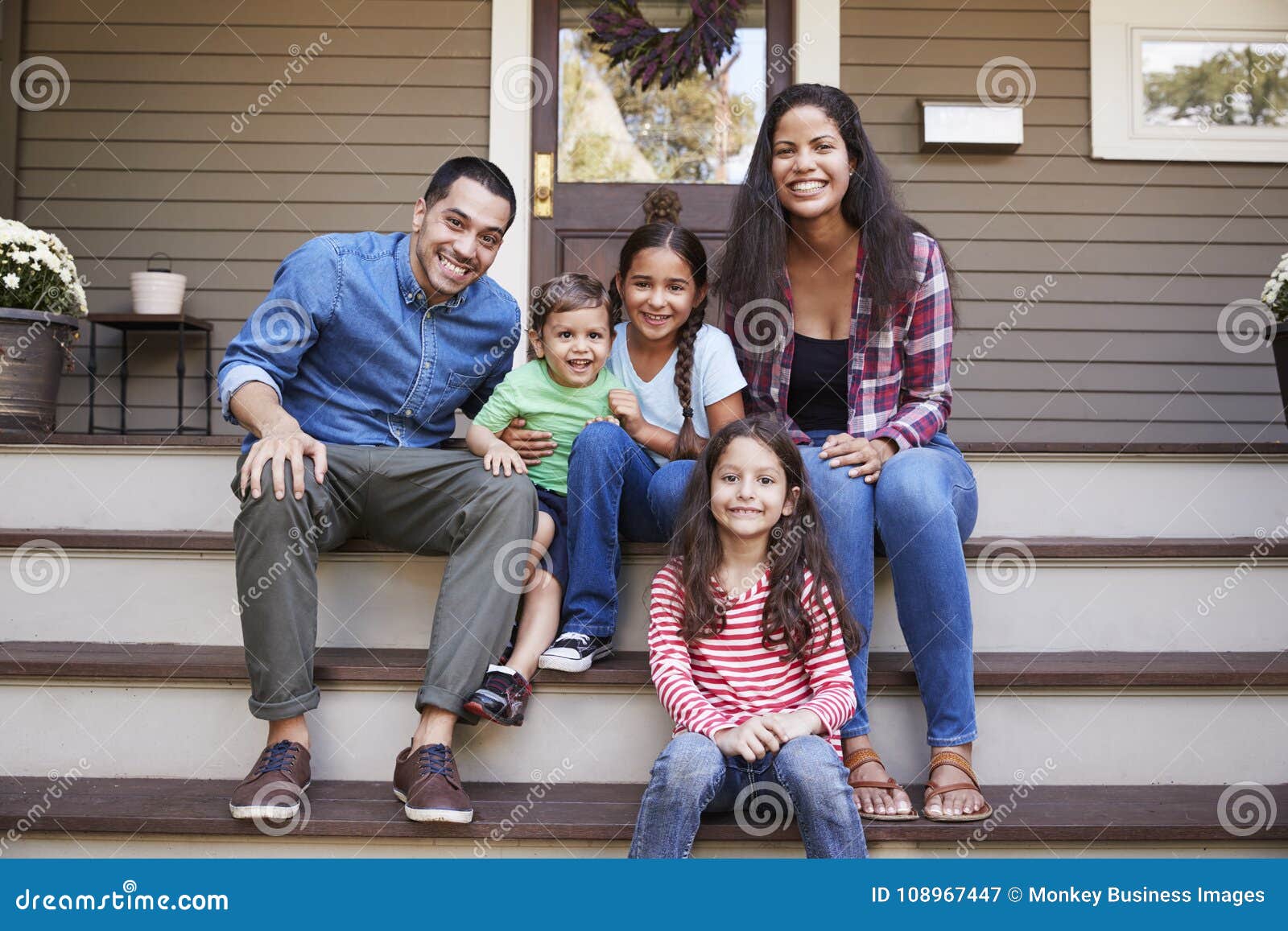 Portrait of Family Sitting on Steps in Front of House Stock Image ...