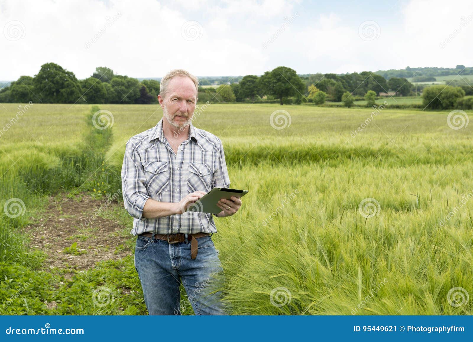 Portrait of Farmer Holding a Tablet Computer in a Field Stock Image ...