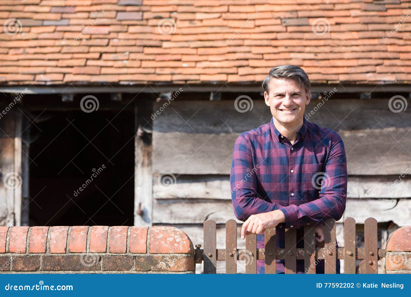 Portrait of Farmer Looking Over Wall of Farm Building Stock Photo ...