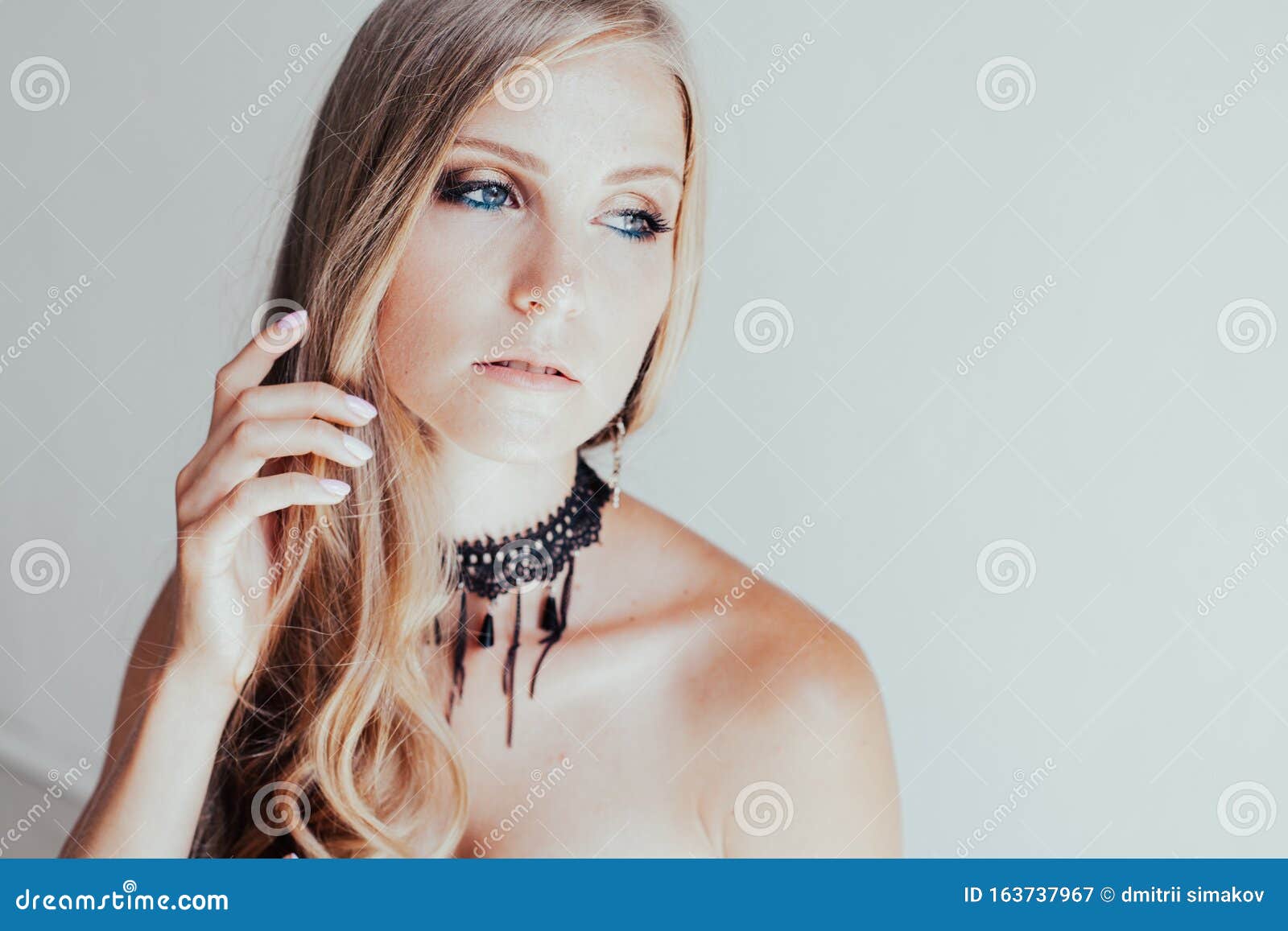 Portrait Of A Beautiful Fashionable Blonde Woman With Blue Eyes Stock