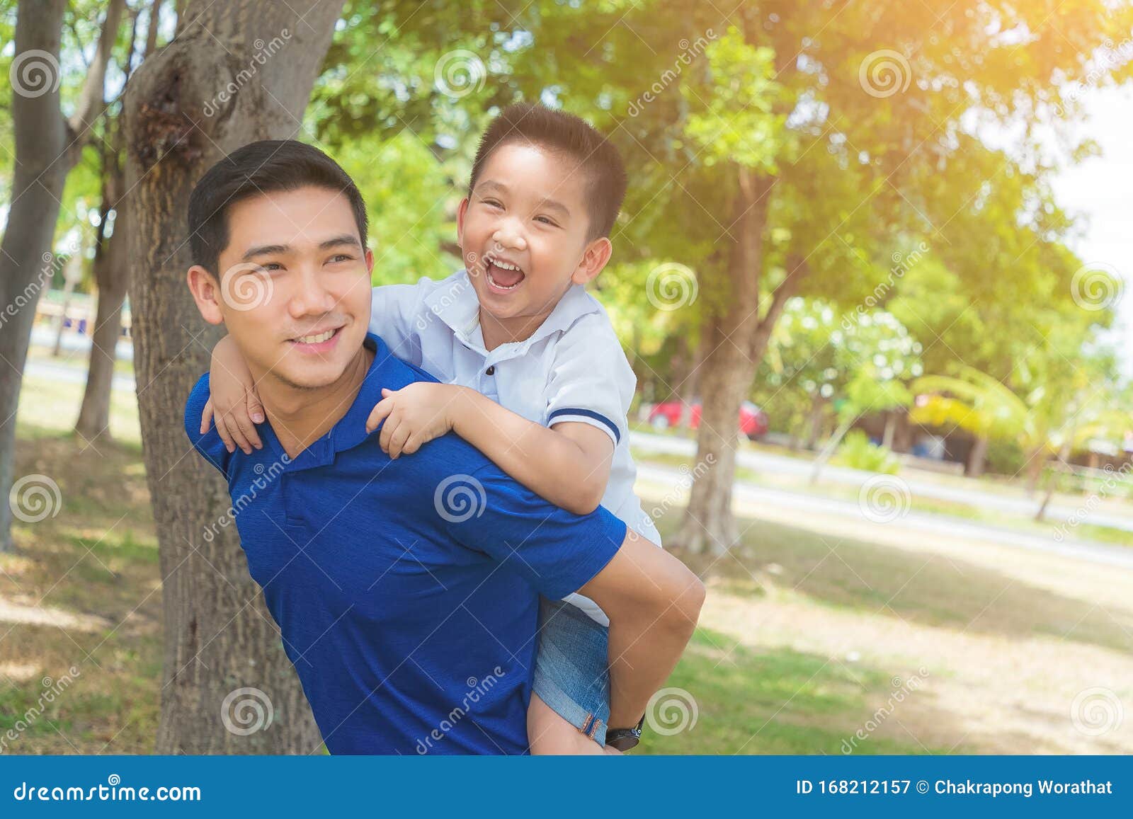 Portrait of a Father Carrying Young Boy on Back at the Park Stock Image ...
