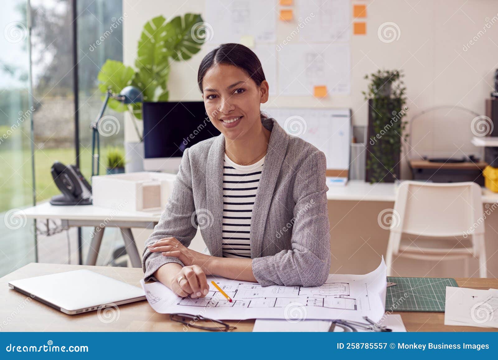 Portrait of Female Architect Working in Office on Plans for New ...