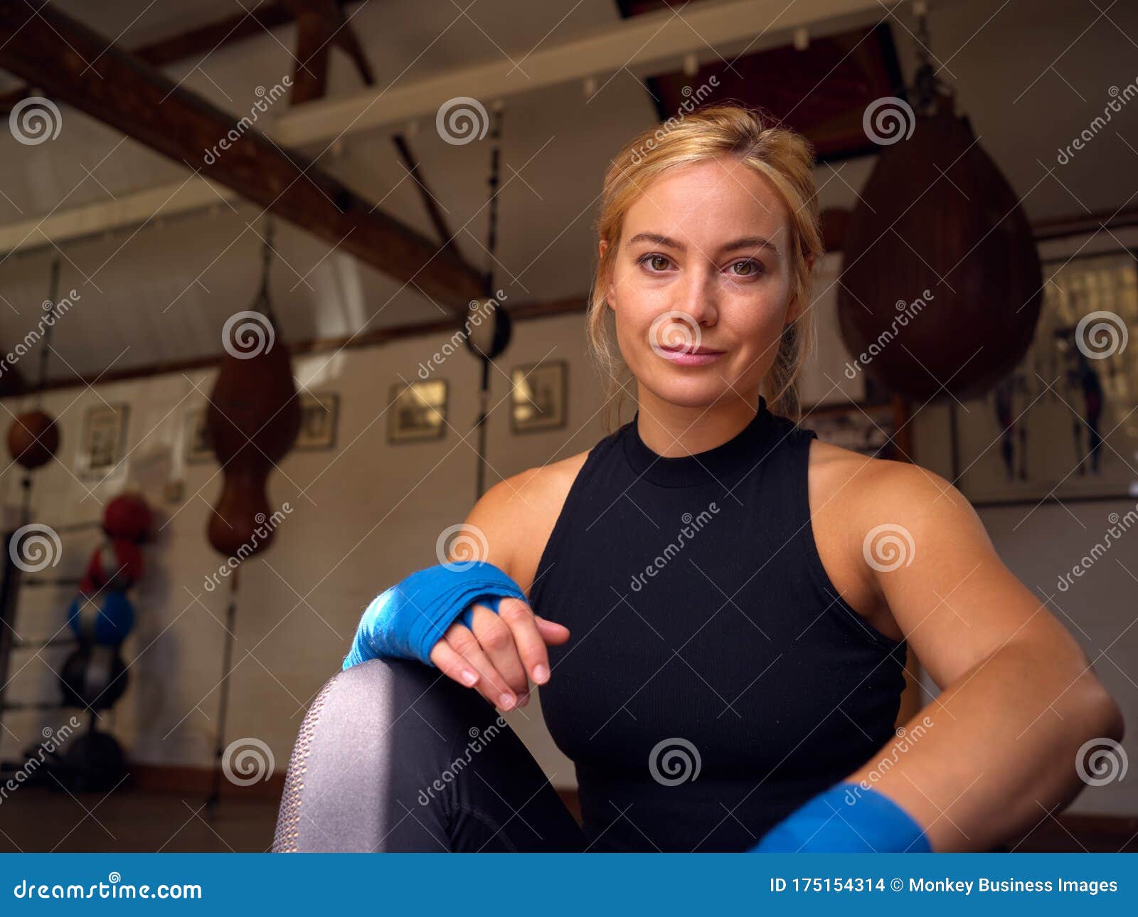 Portrait of Female Boxer with Protective Wraps on Hands Training in Gym ...