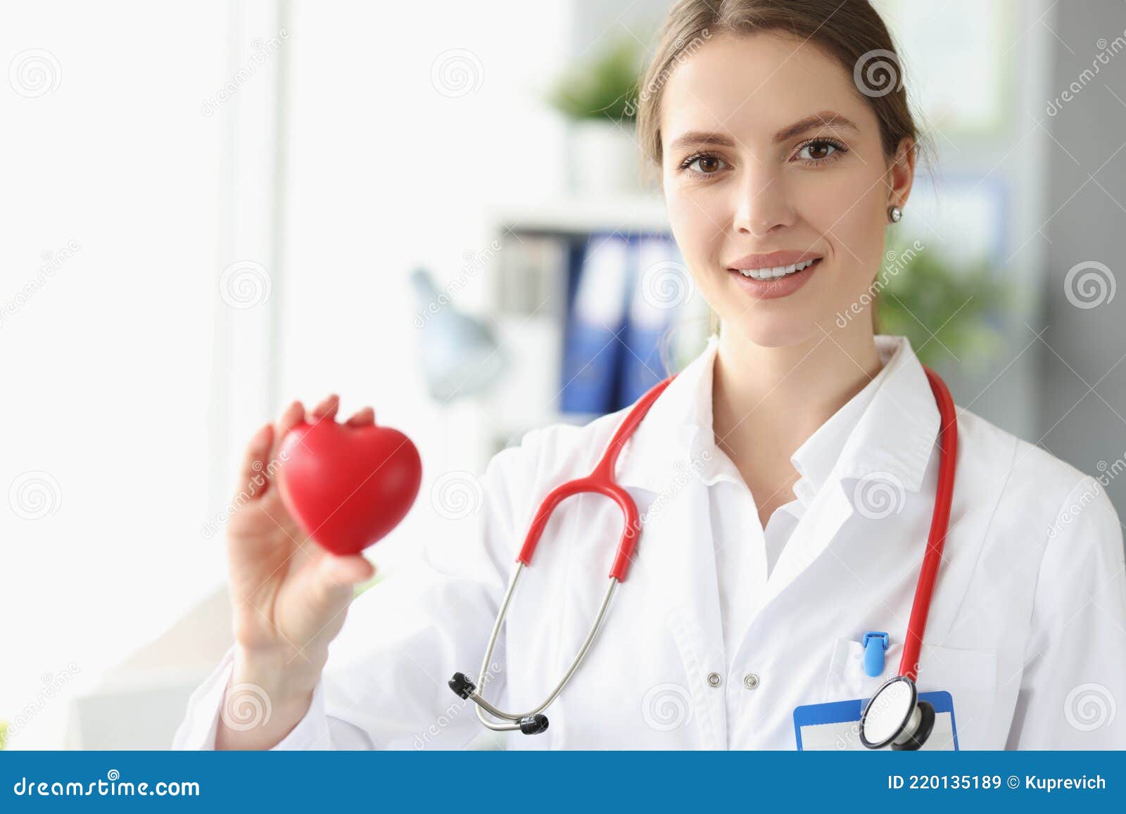 Portrait Of Female Doctor Cardiologist With Small Heart In Her Hand