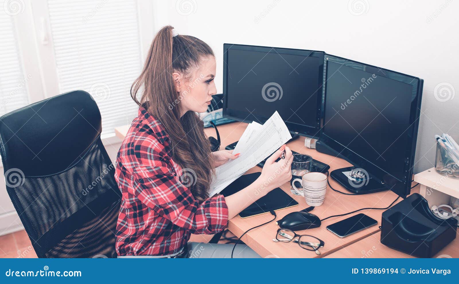 Young Woman Comparing Documents with a Computer Stock Photo - Image of ...