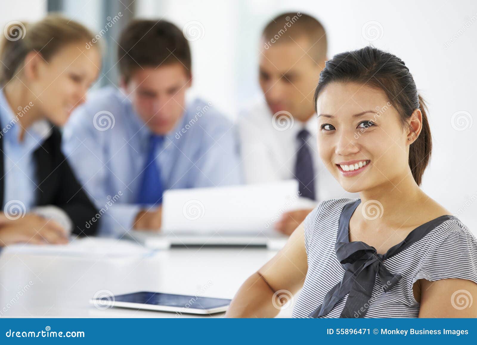 Portrait of Female Executive with Office Meeting in Background Stock ...