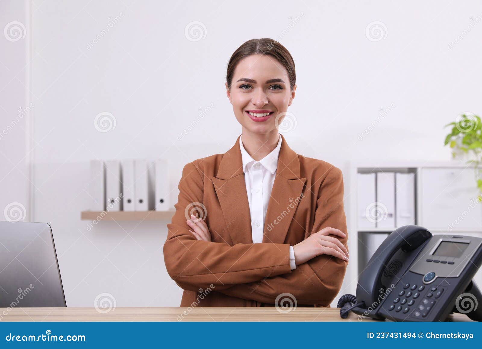 Portrait of Female Receptionist at Desk in Hotel Stock Photo - Image of ...