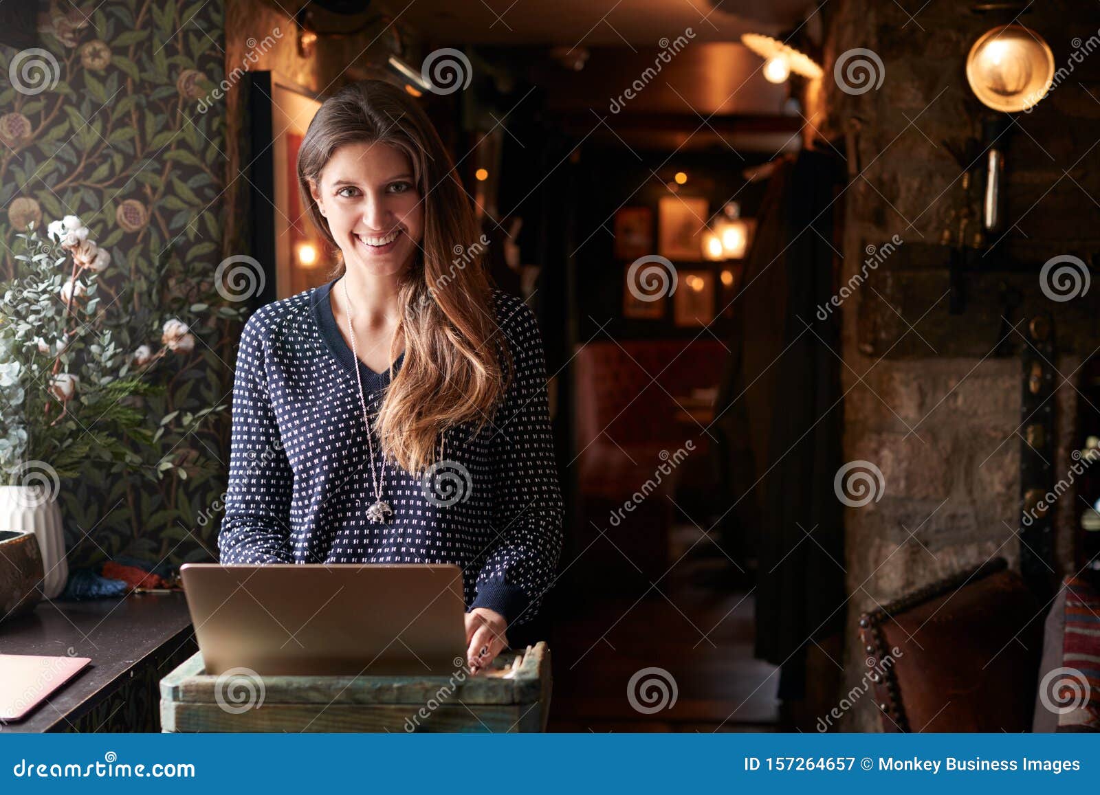 Portrait of Female Receptionist Working on Laptop at Hotel Check in ...