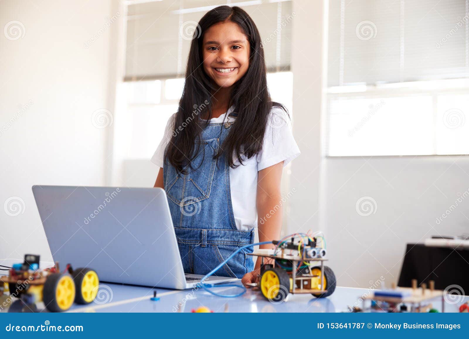 Portrait of Female Student Building and Programing Robot Vehicle in ...