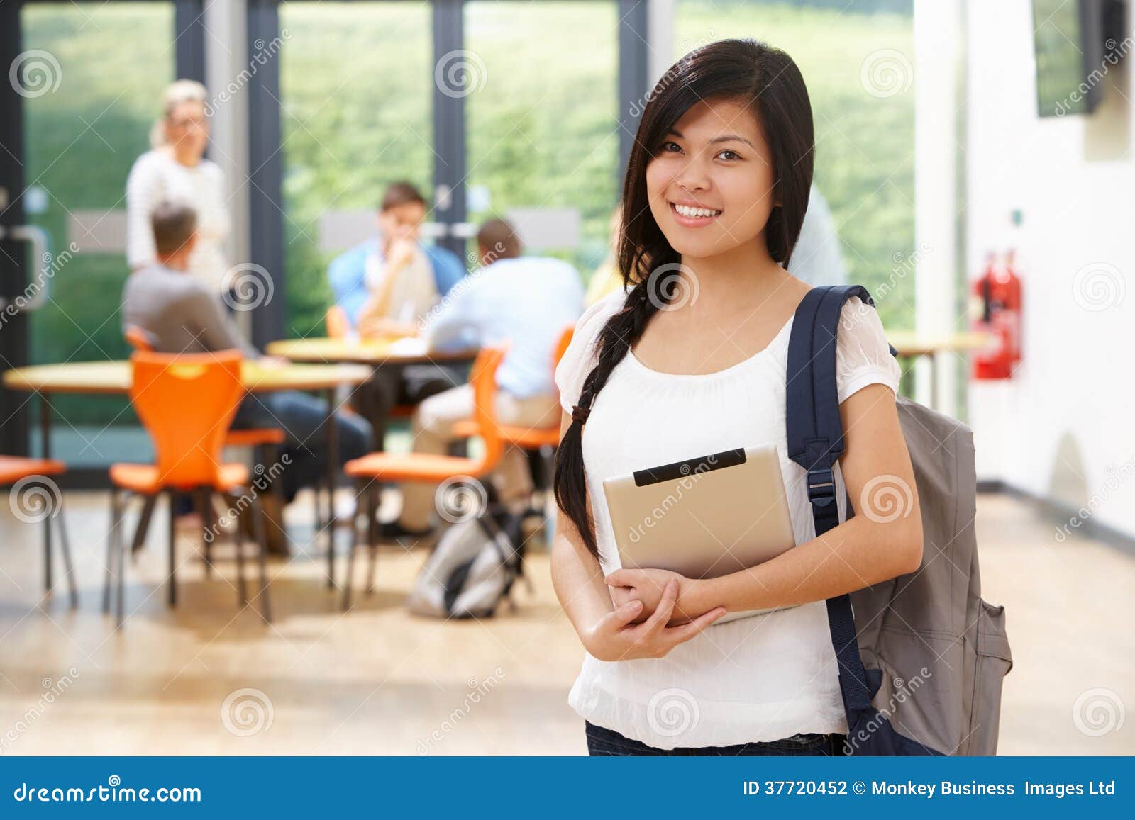 Portrait of Female Student in Classroom with Digital Tablet Stock Photo ...