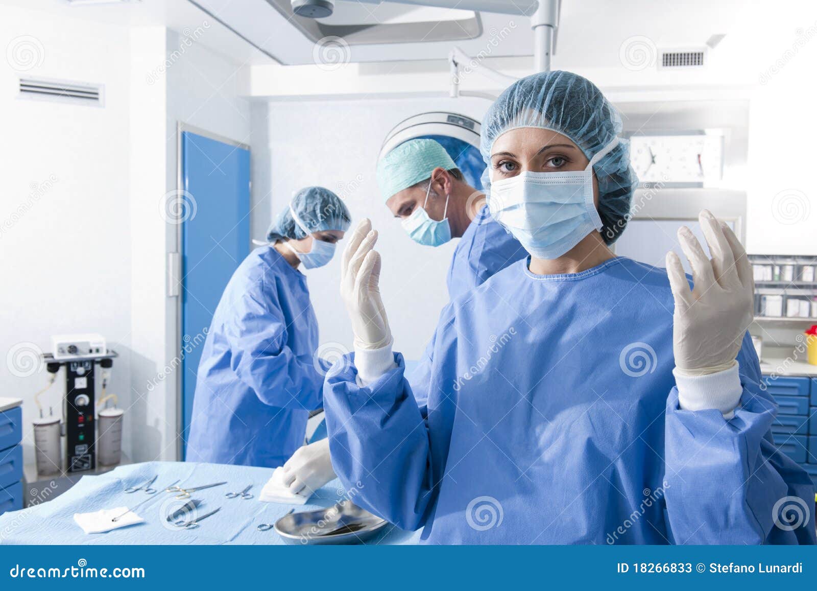 Female Surgeon Or Nurse Wearing A Sterile Suit Putting On Sterile ...