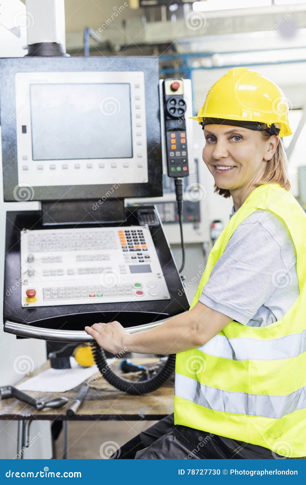 Portrait of Female Worker Operating Machinery at Control Panel in ...