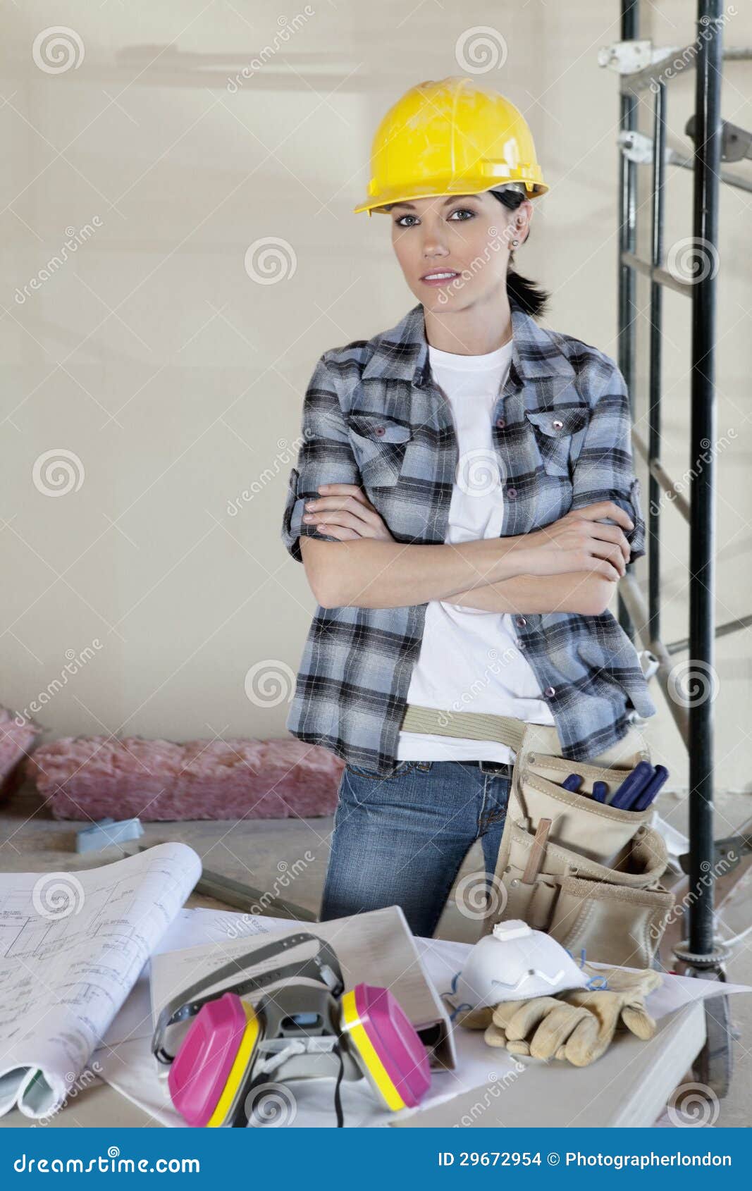 Portrait of Female Worker Standing with Arms Crossed at Construction ...