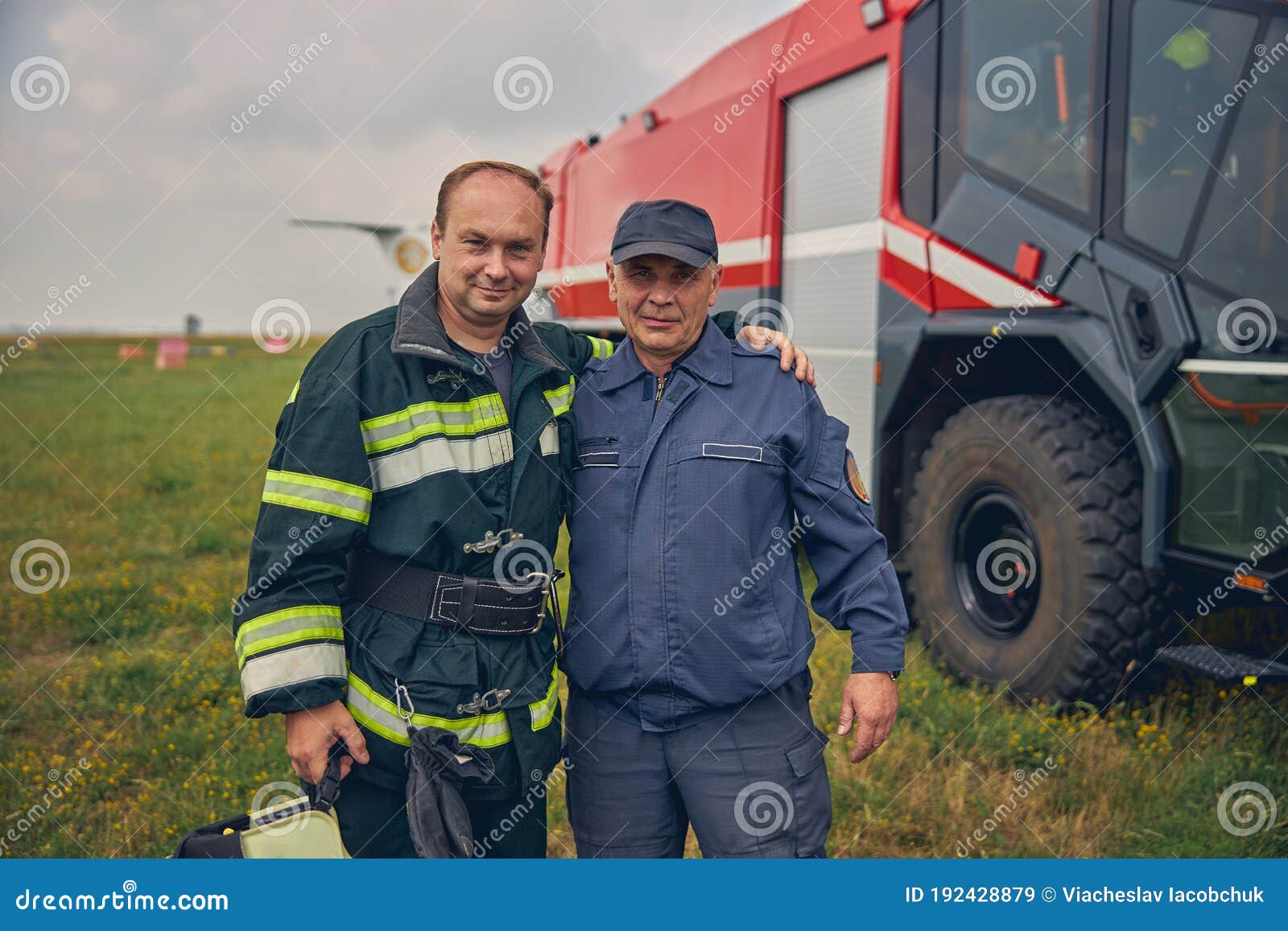Two Men from Fire Brigade Looking at the Photo Camera Stock Image ...