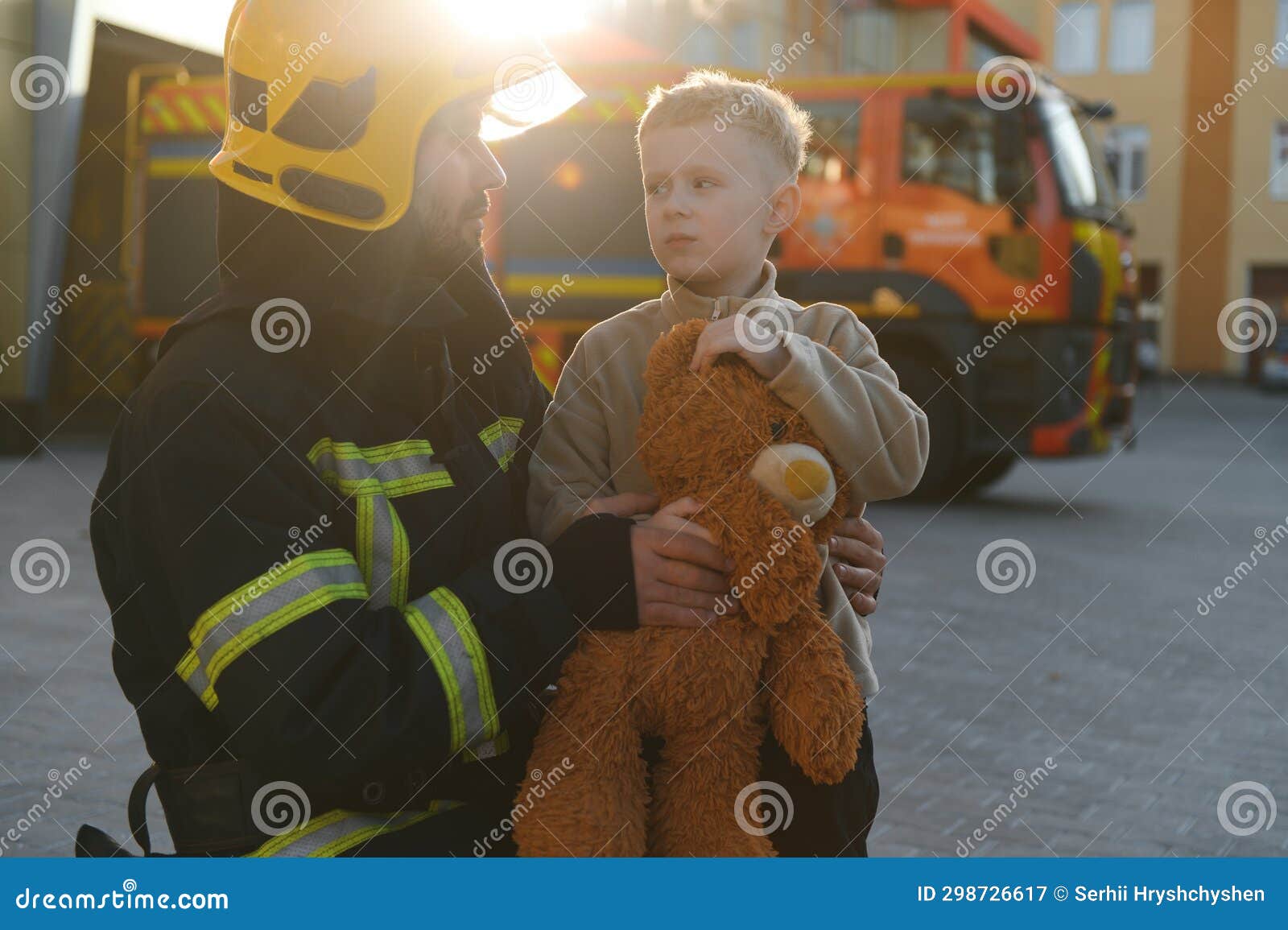 Portrait of a Fireman and a Little Boy with a Teddy Bear. Stock Image ...