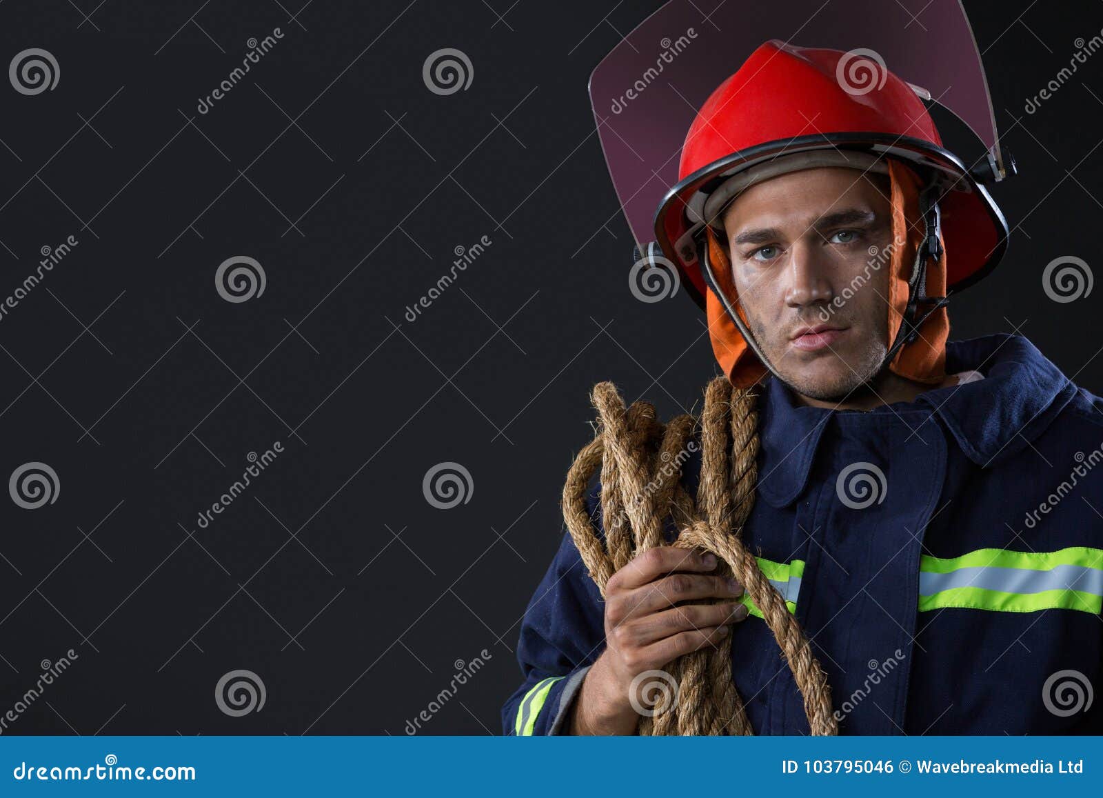 Fireman Standing with a Rope Stock Photo - Image of reflective, danger ...