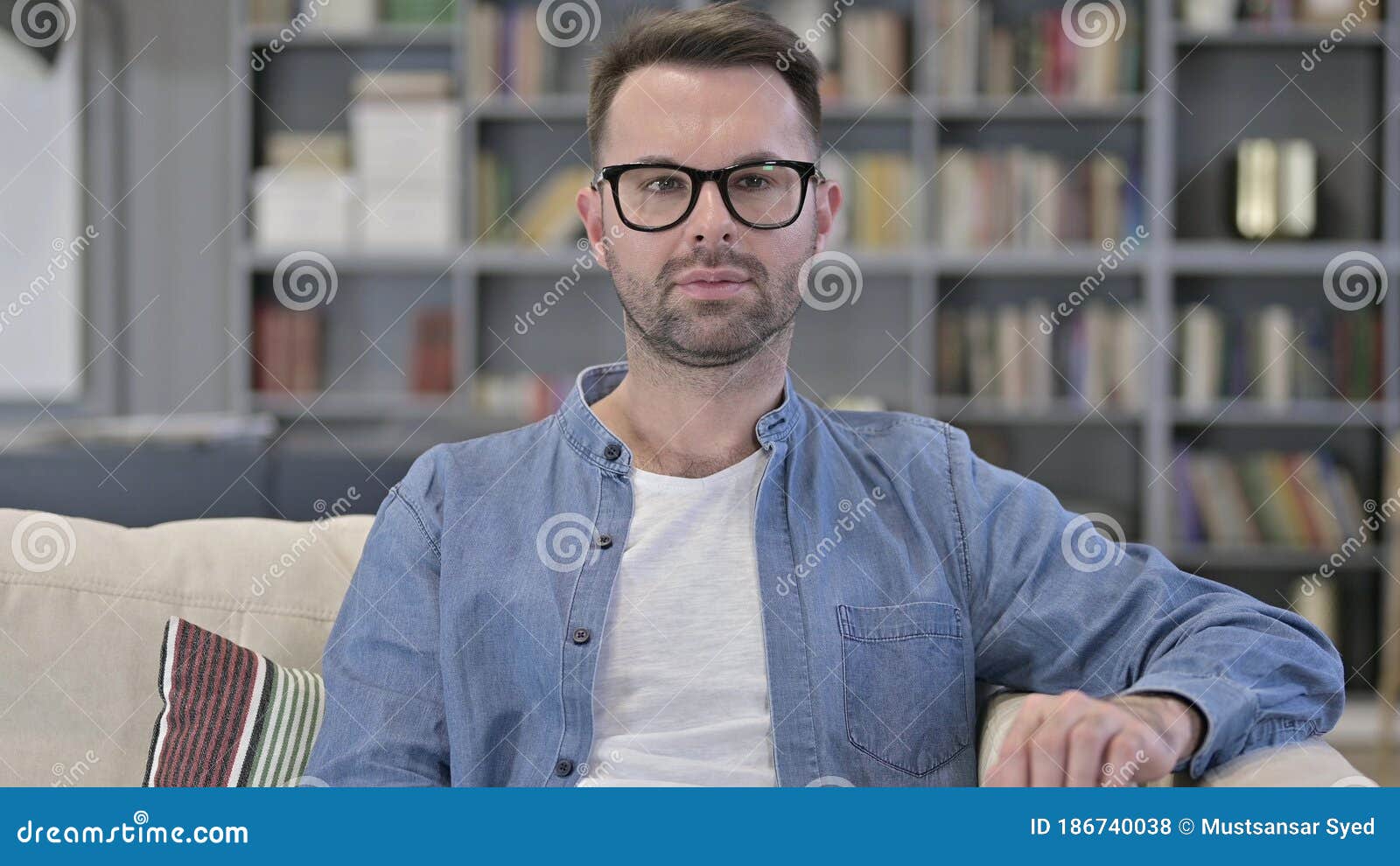 Portrait of Focused Man Sitting on Sofa and Thinking Stock Photo ...