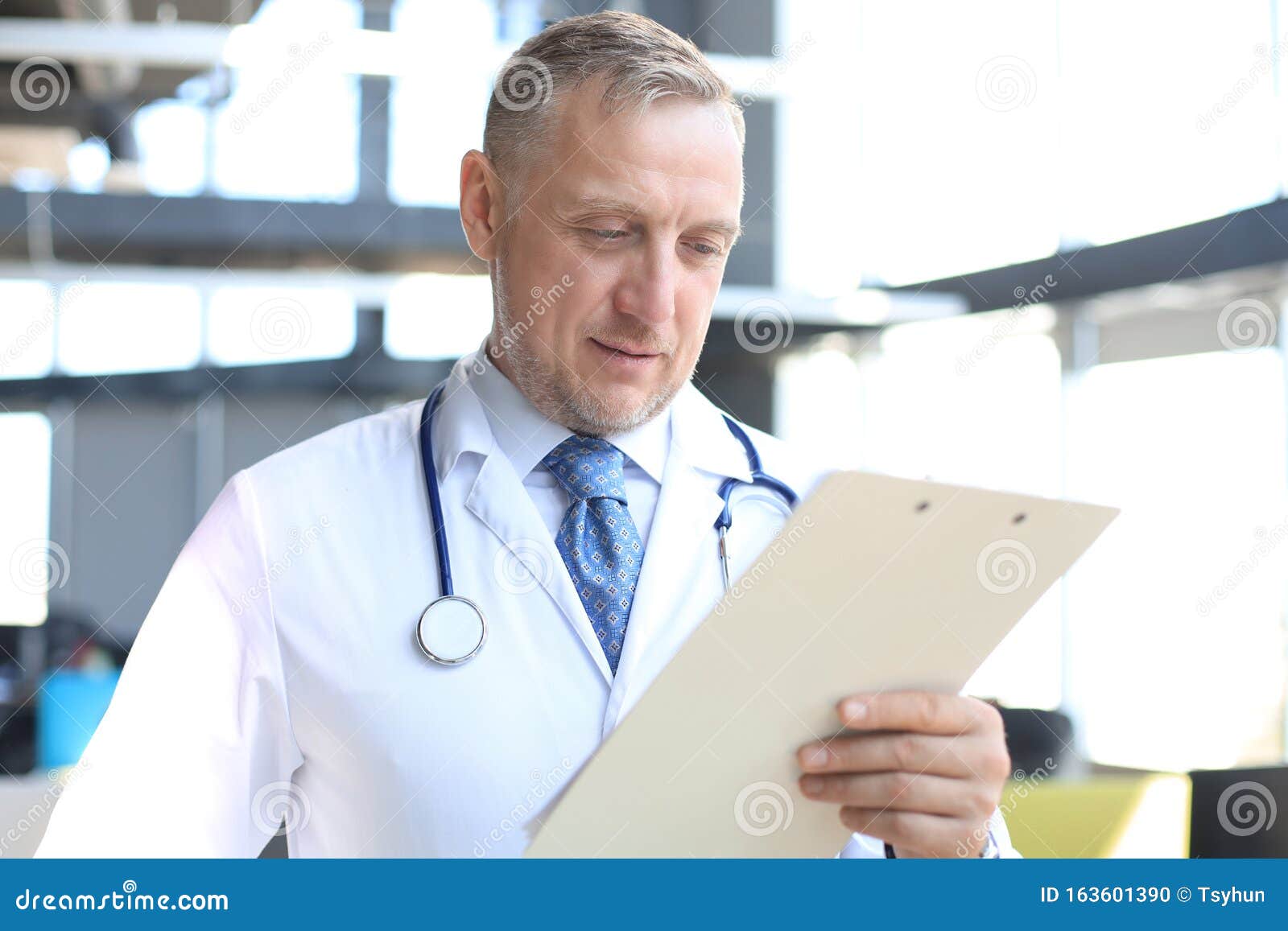 Portrait of Focused Senior Doctor Writing Reports Stock Photo - Image ...