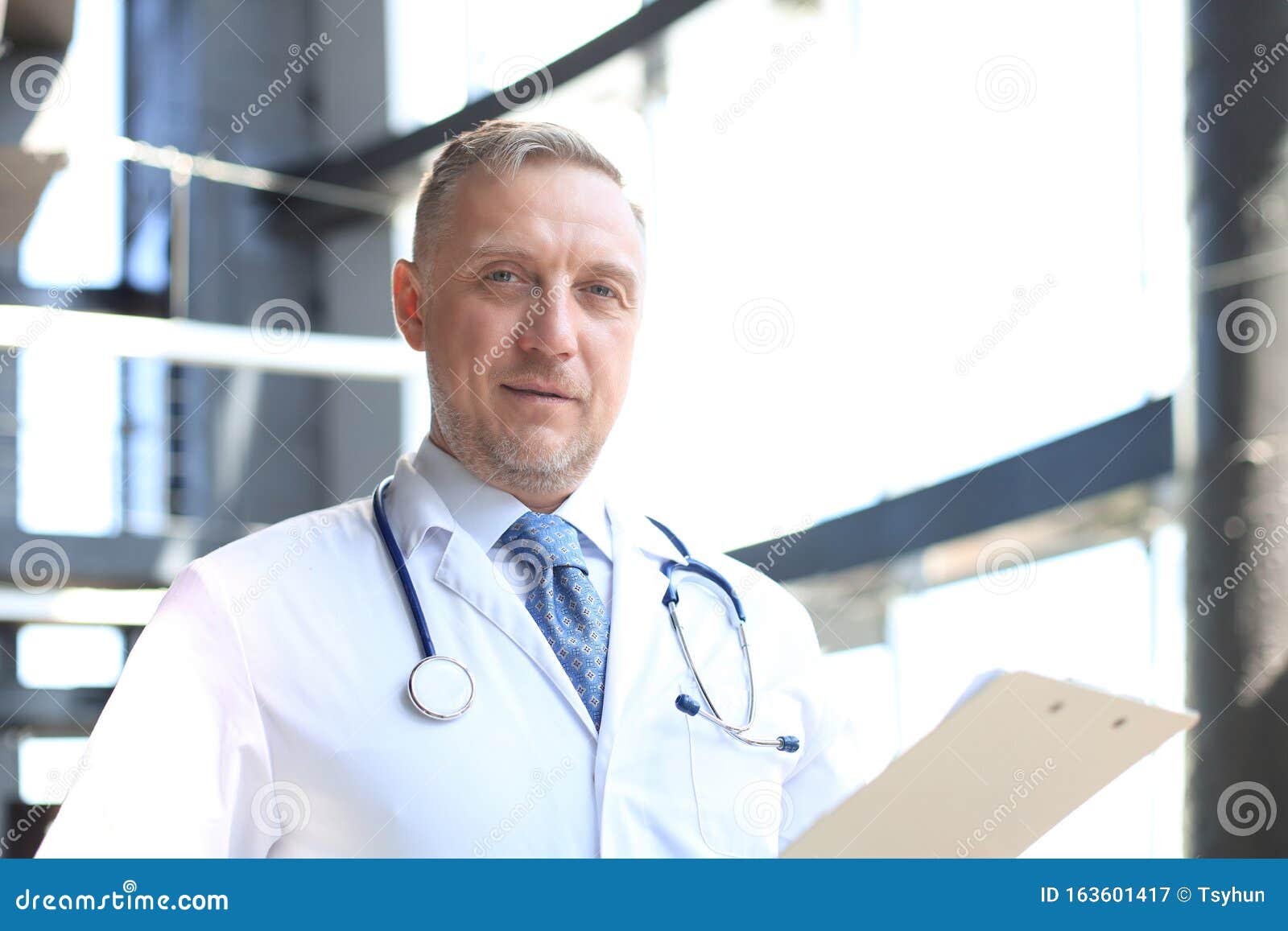 Portrait of Focused Senior Doctor Writing Reports Stock Image - Image ...