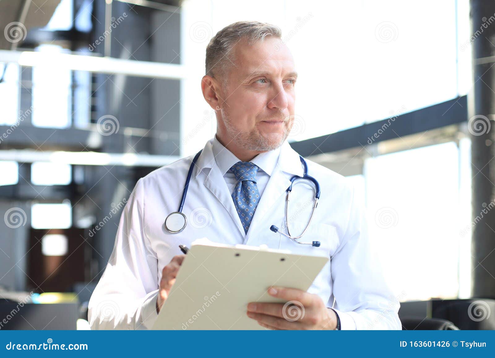 Portrait of Focused Senior Doctor Writing Reports Stock Photo - Image ...