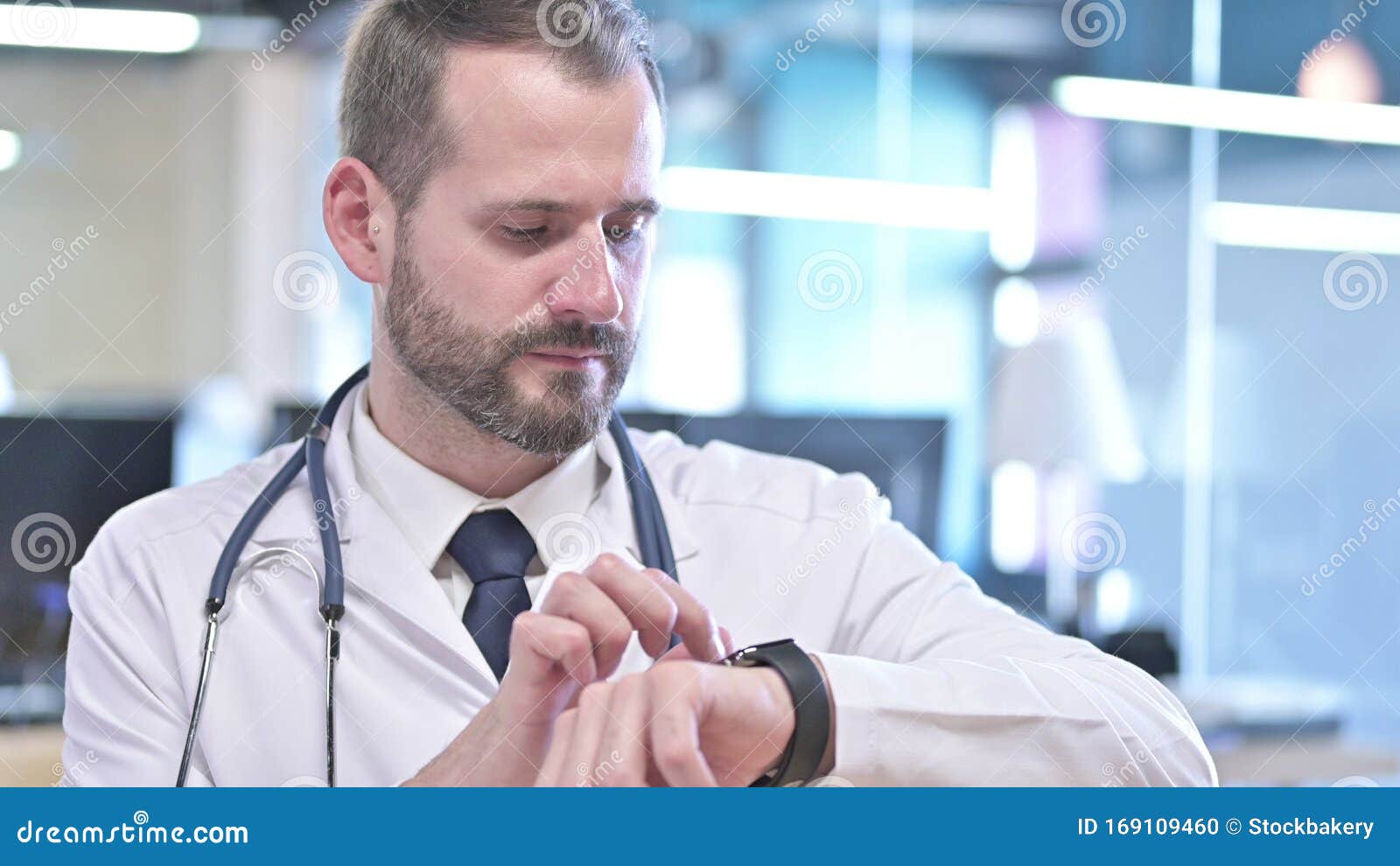The Portrait of Focused Young Doctor Using Smart Watch Stock Photo ...