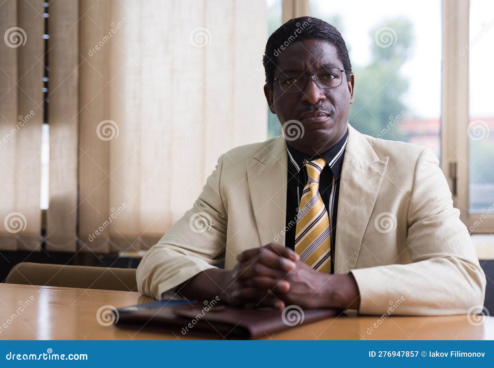 Portrait of Friendly Businessman at Negotiation Table in Office Stock ...