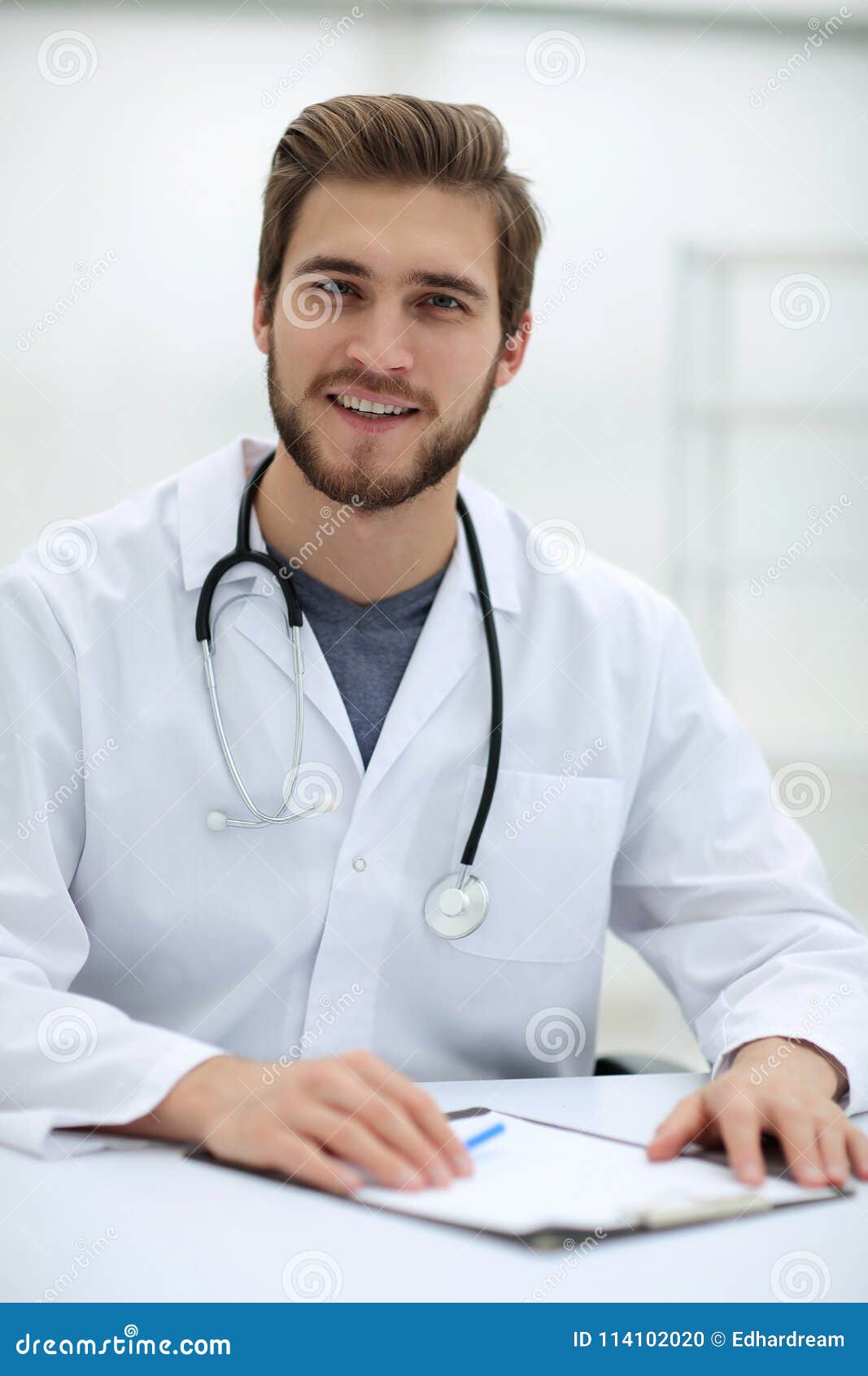 Friendly Doctor Sitting Behind a Desk Stock Photo - Image of assistance ...