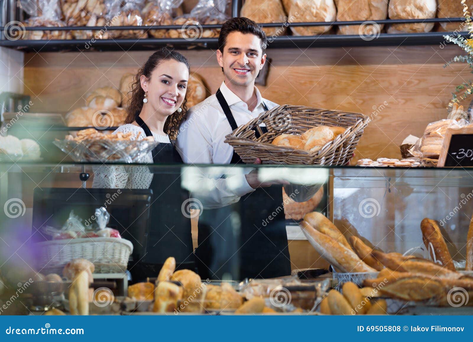 Portrait of Friendly Young Smiling Couple at Bakery Display Stock Photo ...
