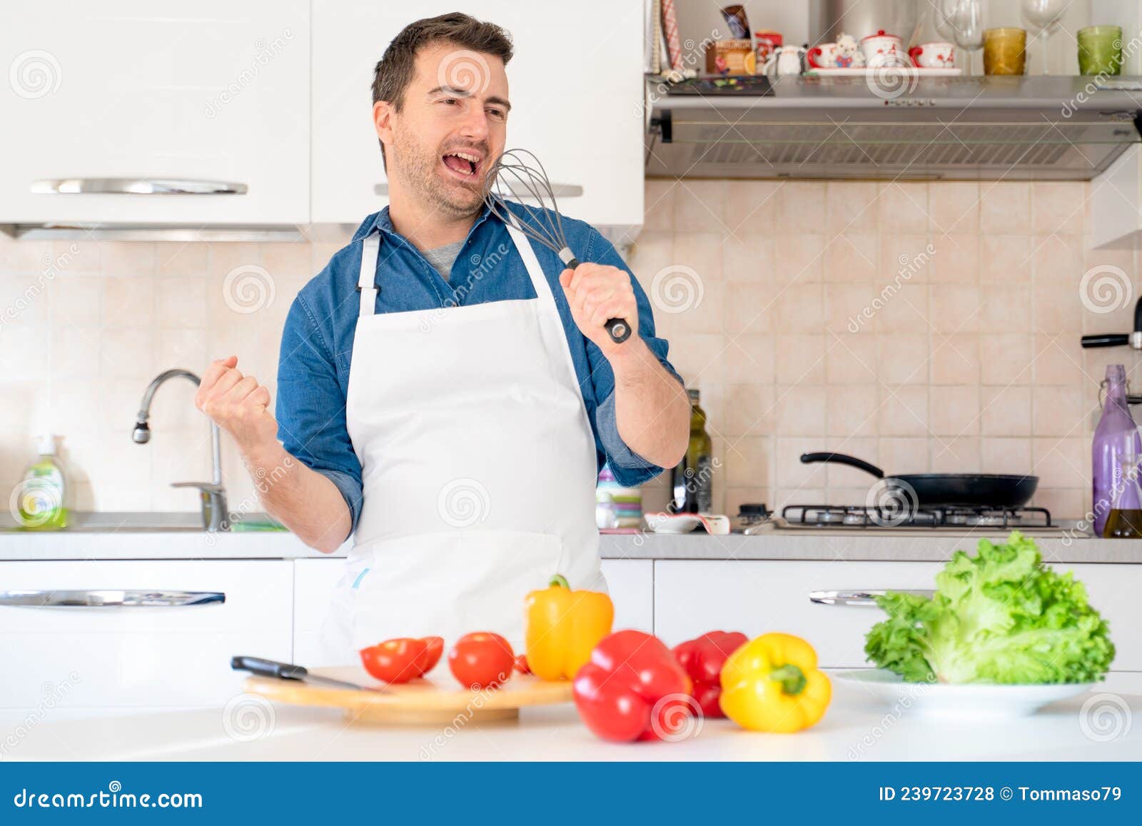 One Man is Singing in the Kitchen while Cooking Stock Photo - Image of ...