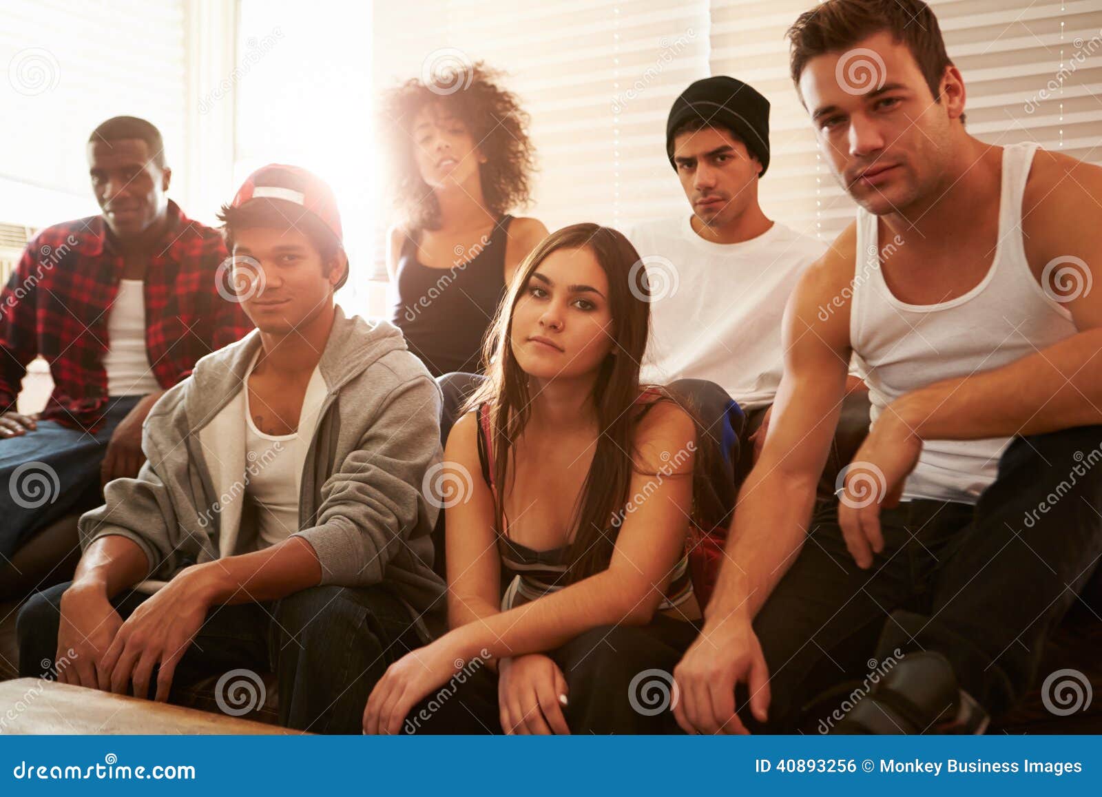 Portrait Of Gang Members Sitting On Sofa In House Royalty-Free Stock ...