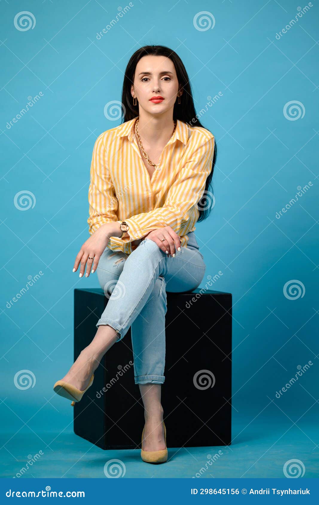 Portrait of a Girl on a Blue Background Sitting on a Black Cube. Stock ...