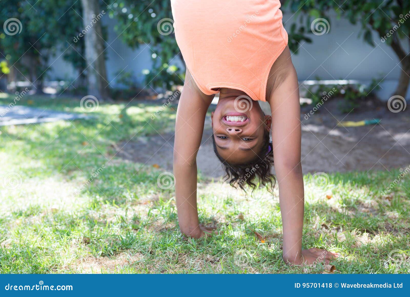 Portrait of Girl Practicing Handstand Stock Photo - Image of grass ...