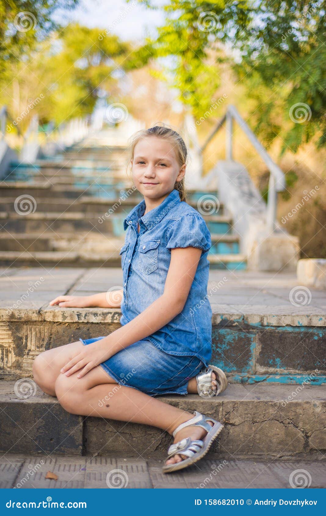 Portrait of a Girl Sitting in the Park on the Steps Stock Photo - Image ...