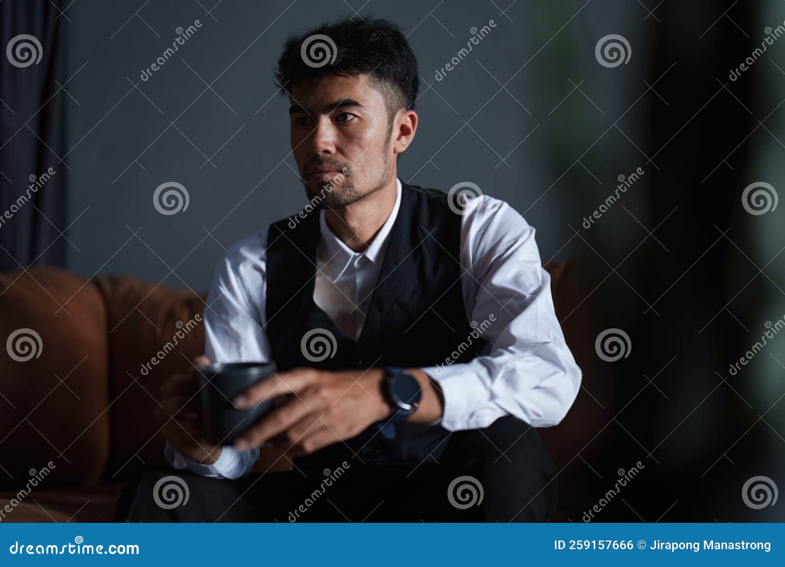 Portrait of a Good Looking and Discreet Asian Man Sitting on the Sofa ...