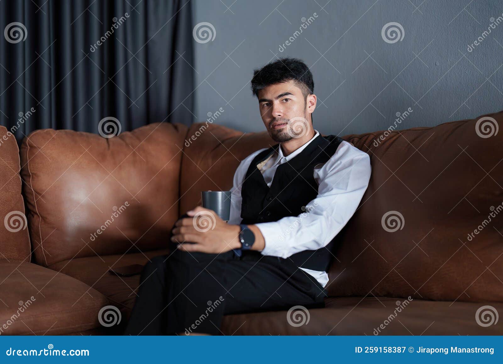 Portrait of a Good Looking and Discreet Asian Man Sitting on the Sofa ...
