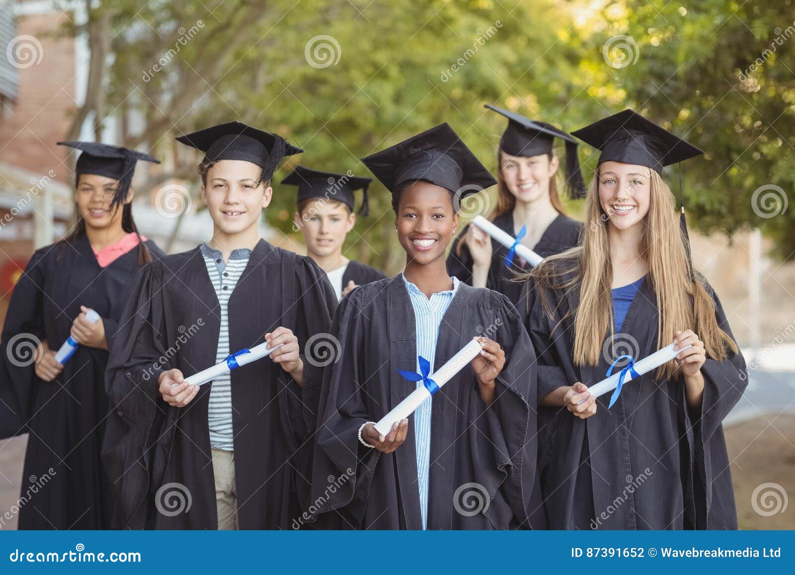 Portrait of Graduate School Kids Standing with Degree Scroll in Campus ...