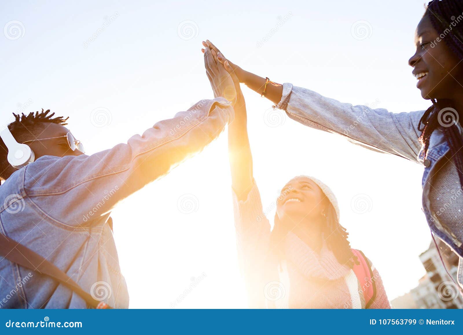 Group of Friends Shaking Hands in the Street. Stock Image - Image of ...