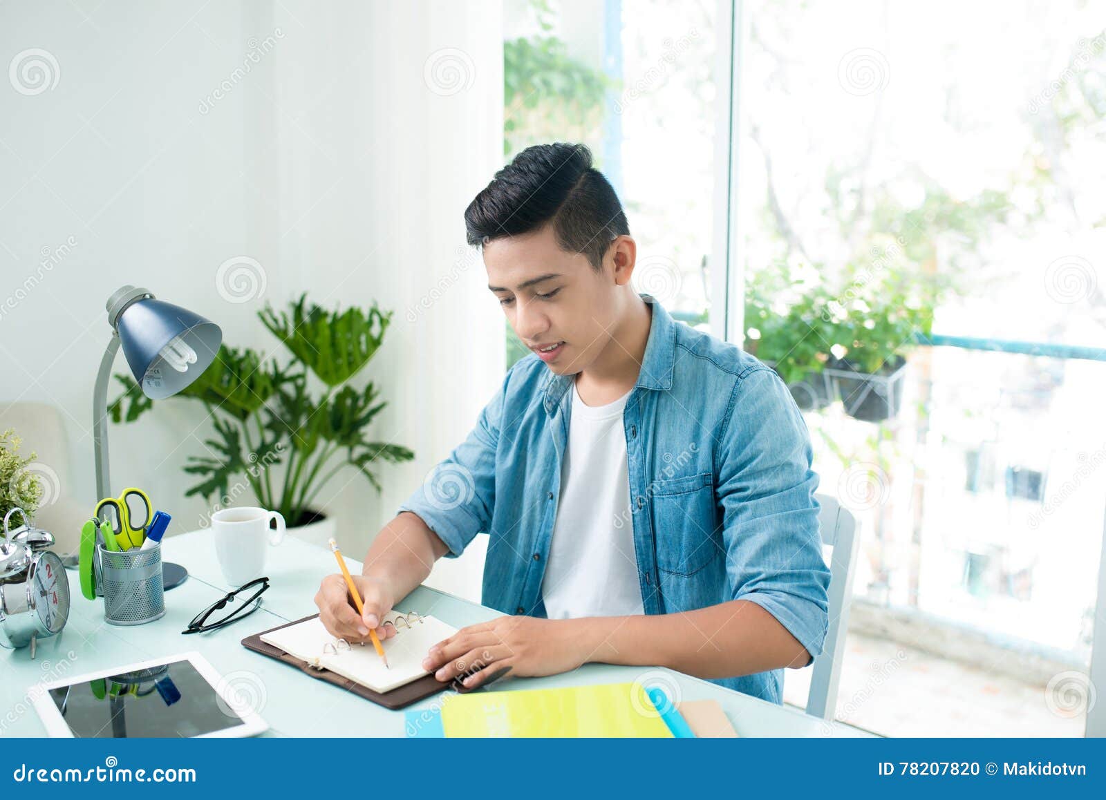 Portrait of Handsome Asian Young Writing Something on Notebook a Stock ...