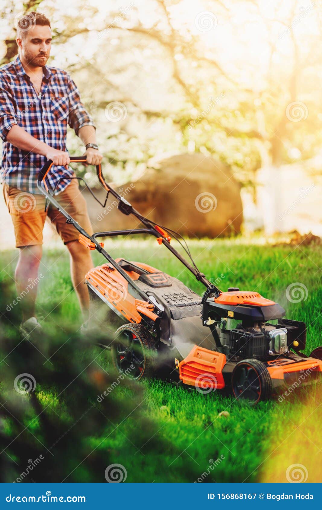 Portrait of Handsome Gardener Worker Using Lawnmower and Cutting the ...