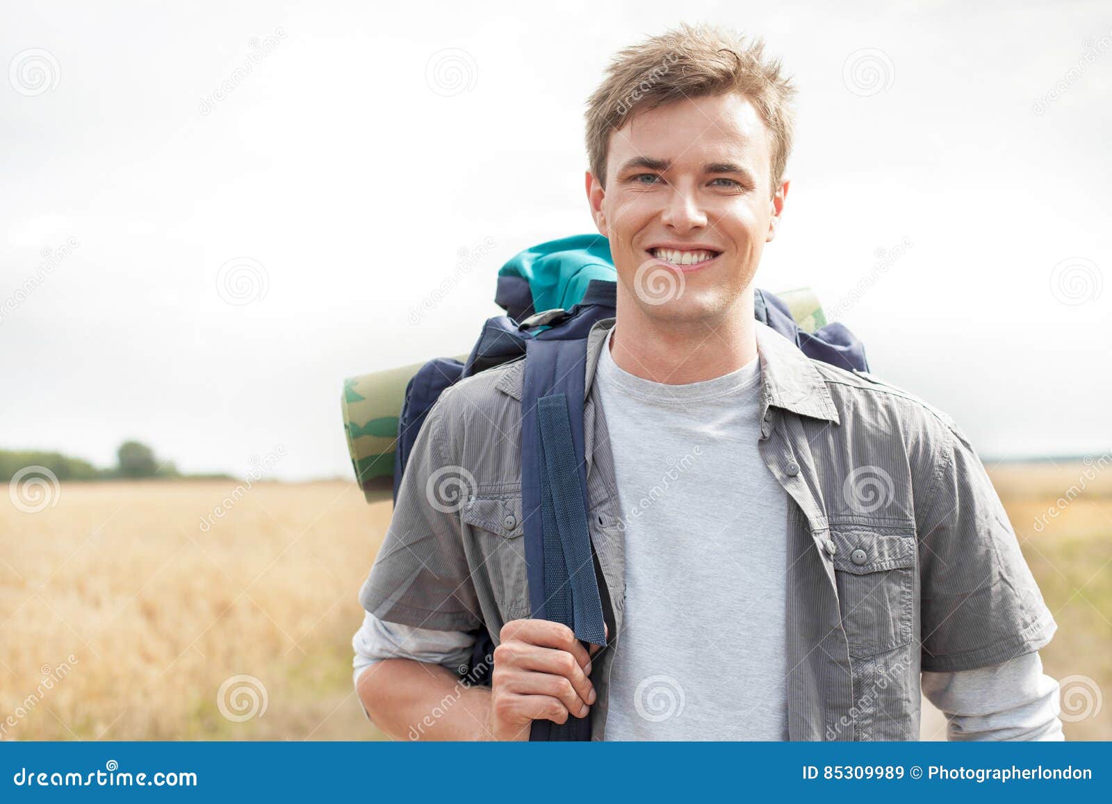 Portrait of Handsome Male Hiker with Backpack Standing on Field Stock ...
