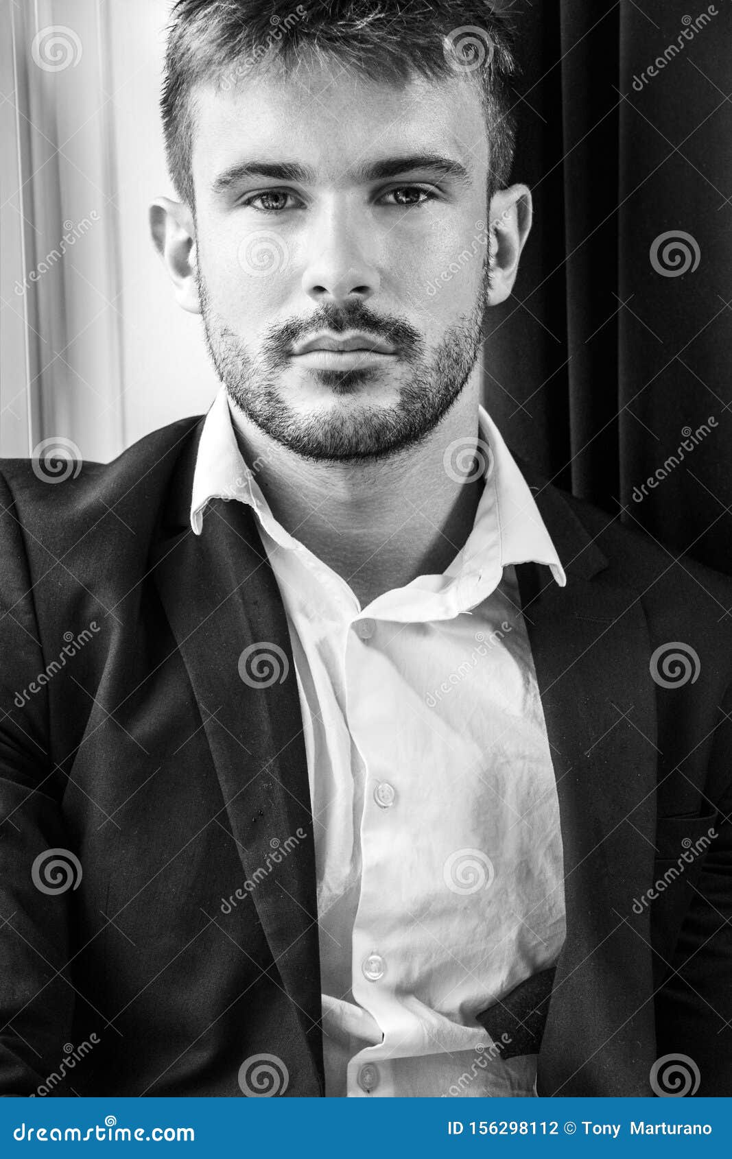 Portrait Of Handsome Man With Beard Wearing Shirt And Jacket Looking At