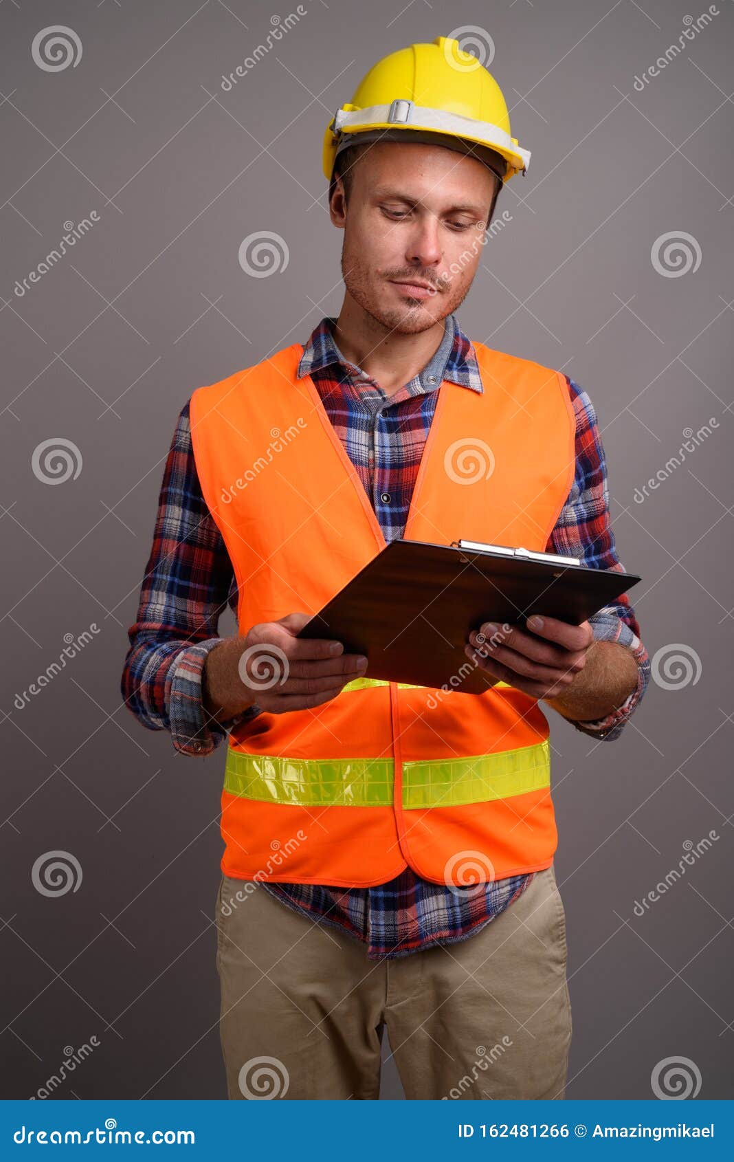 Portrait of Handsome Man Construction Worker Against Gray Background ...