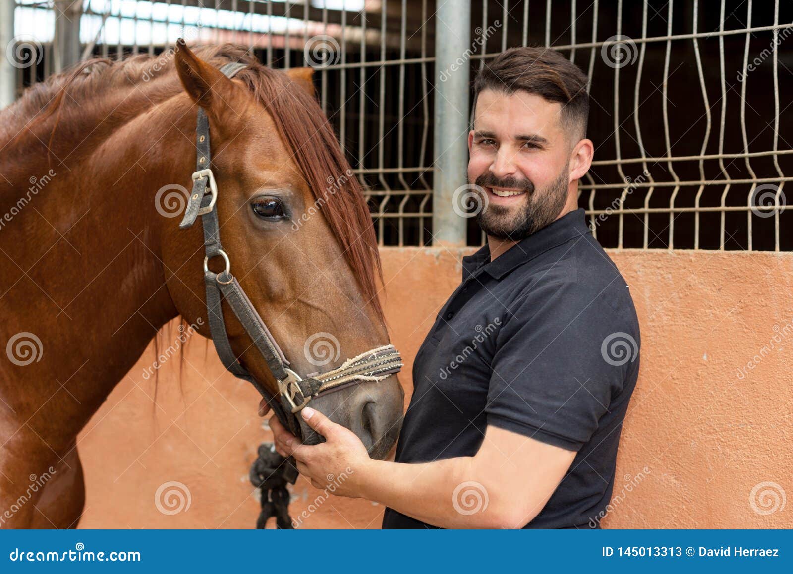 Portrait of a Handsome Man with His Horse Standing at the Stable Stock ...