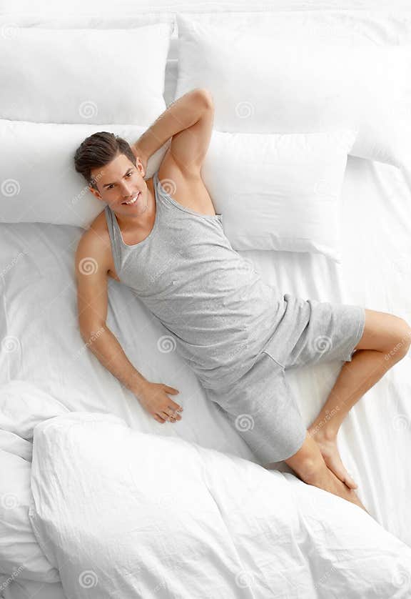 Portrait Of Handsome Man Lying On Large Bed Stock Image Image Of