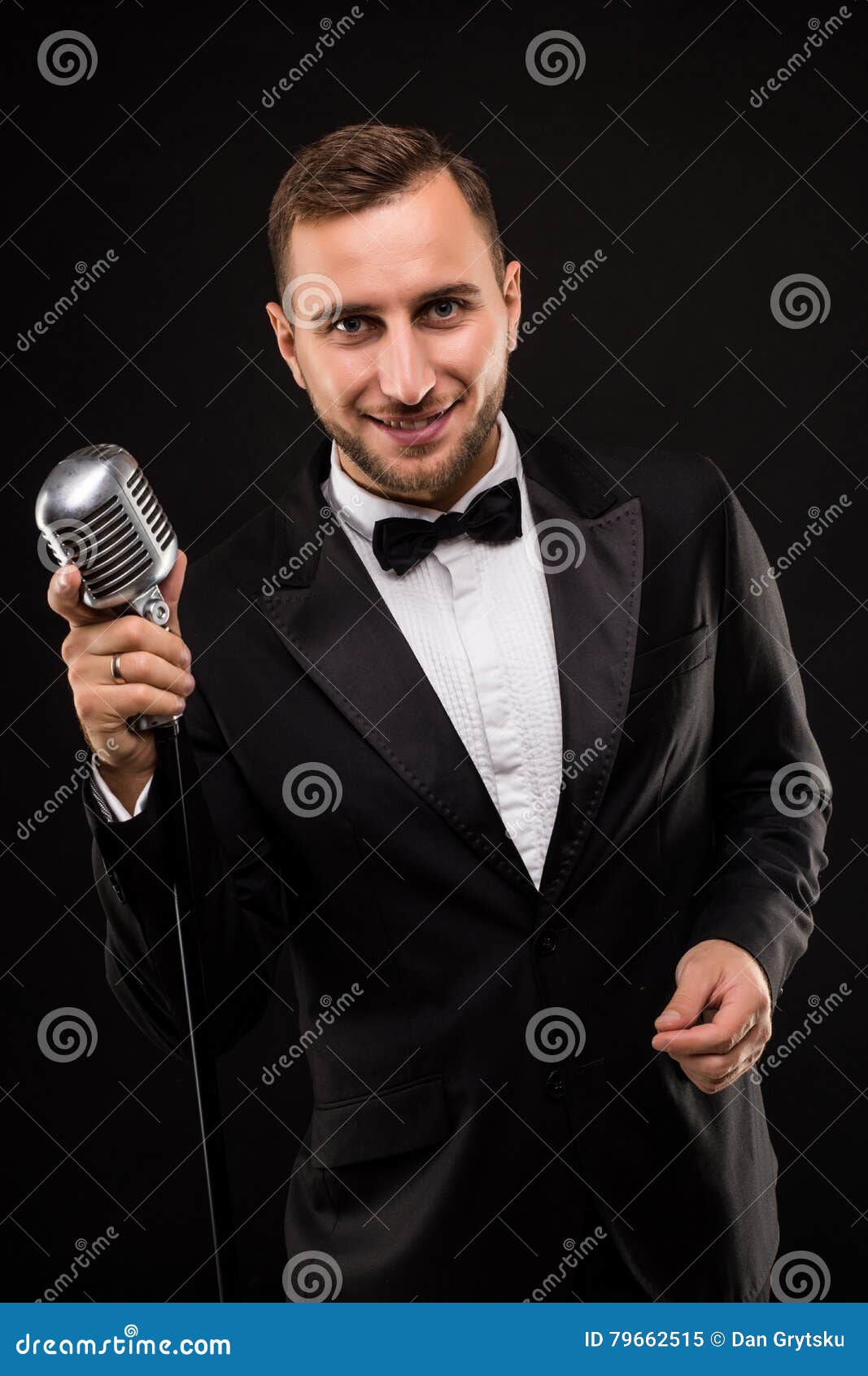 Portrait of Handsome Man Sing on Microphone on Black Background Stock ...