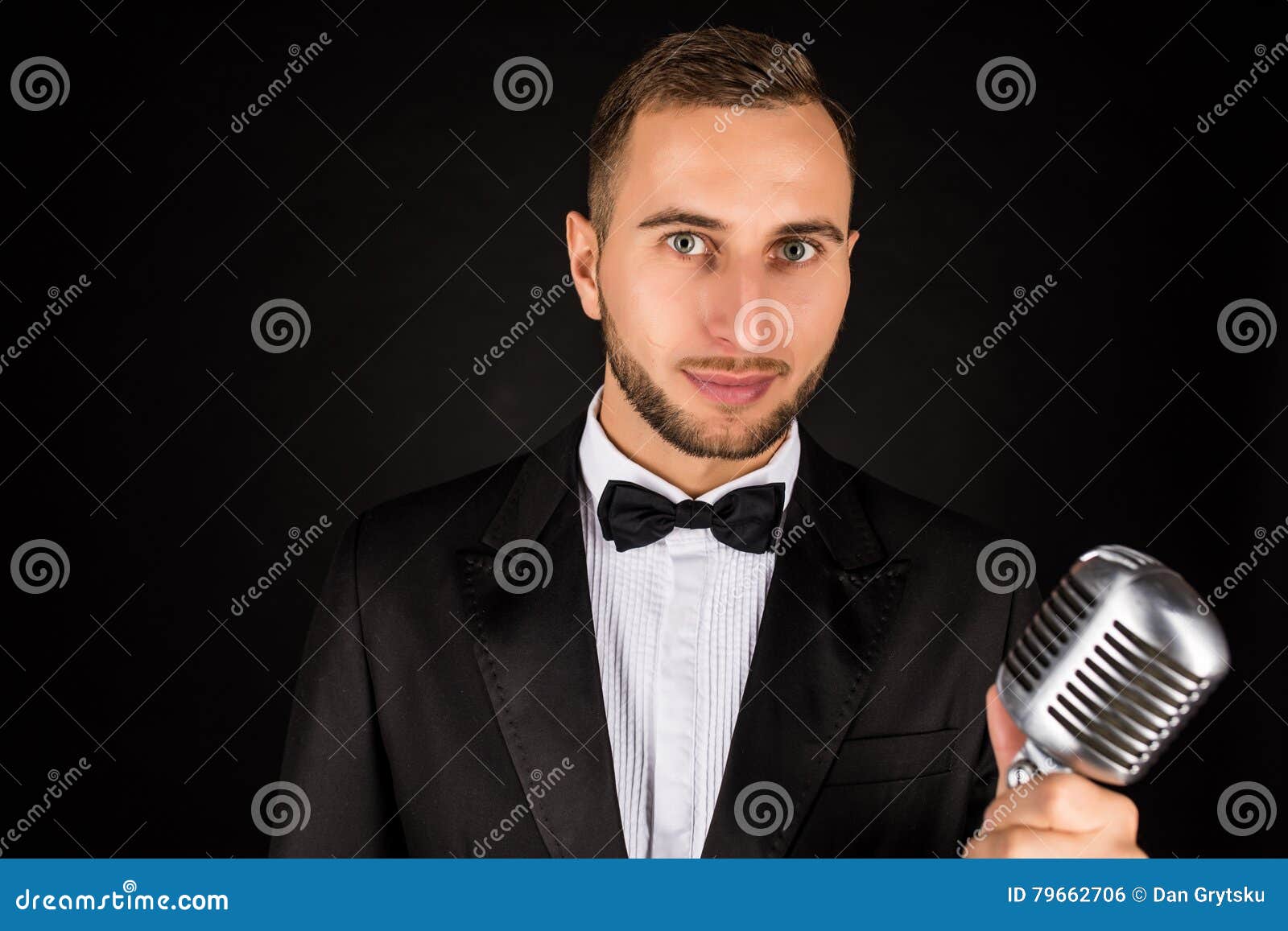 Portrait of Handsome Man Sing on Microphone on Black Background. Stock ...