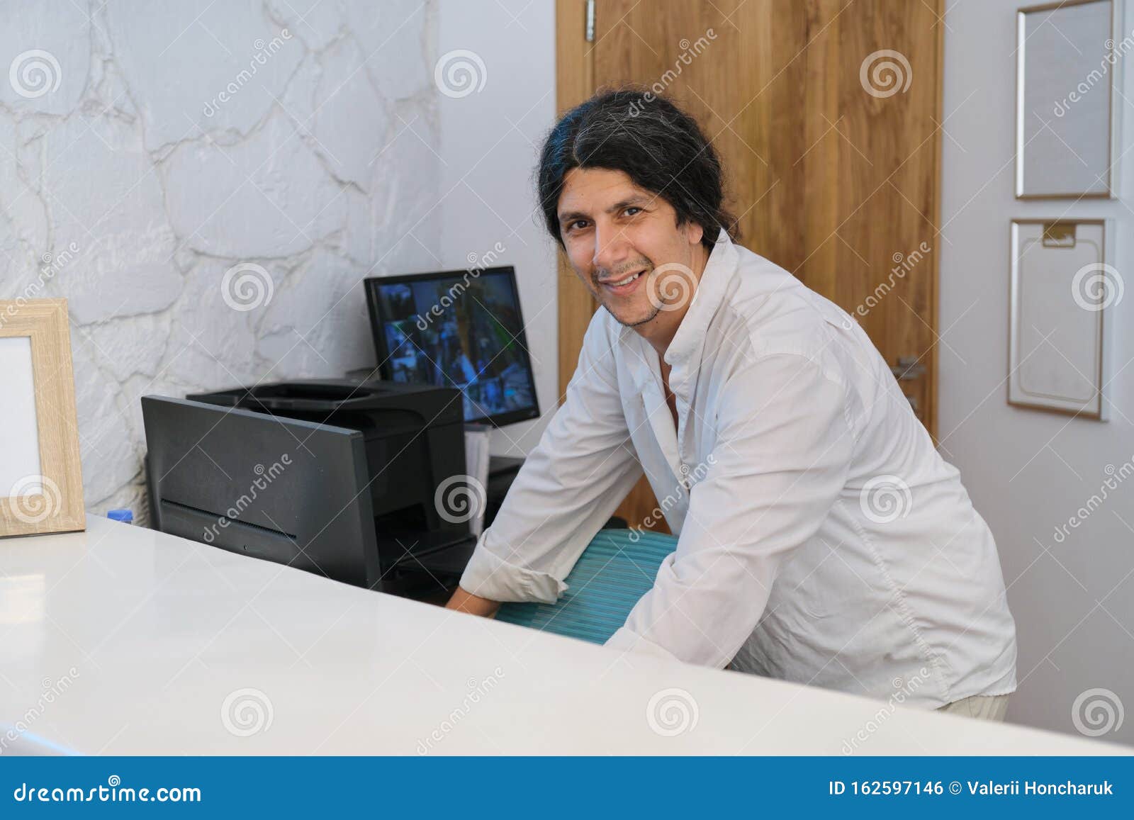 Portrait of Handsome Man Working at the Reception Desk in Resort Hotel ...